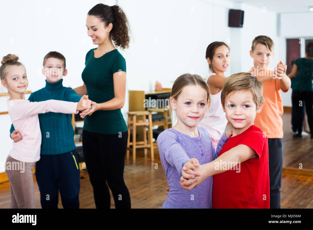 Group of children dancing pair dance in dance hall Stock Photo - Alamy