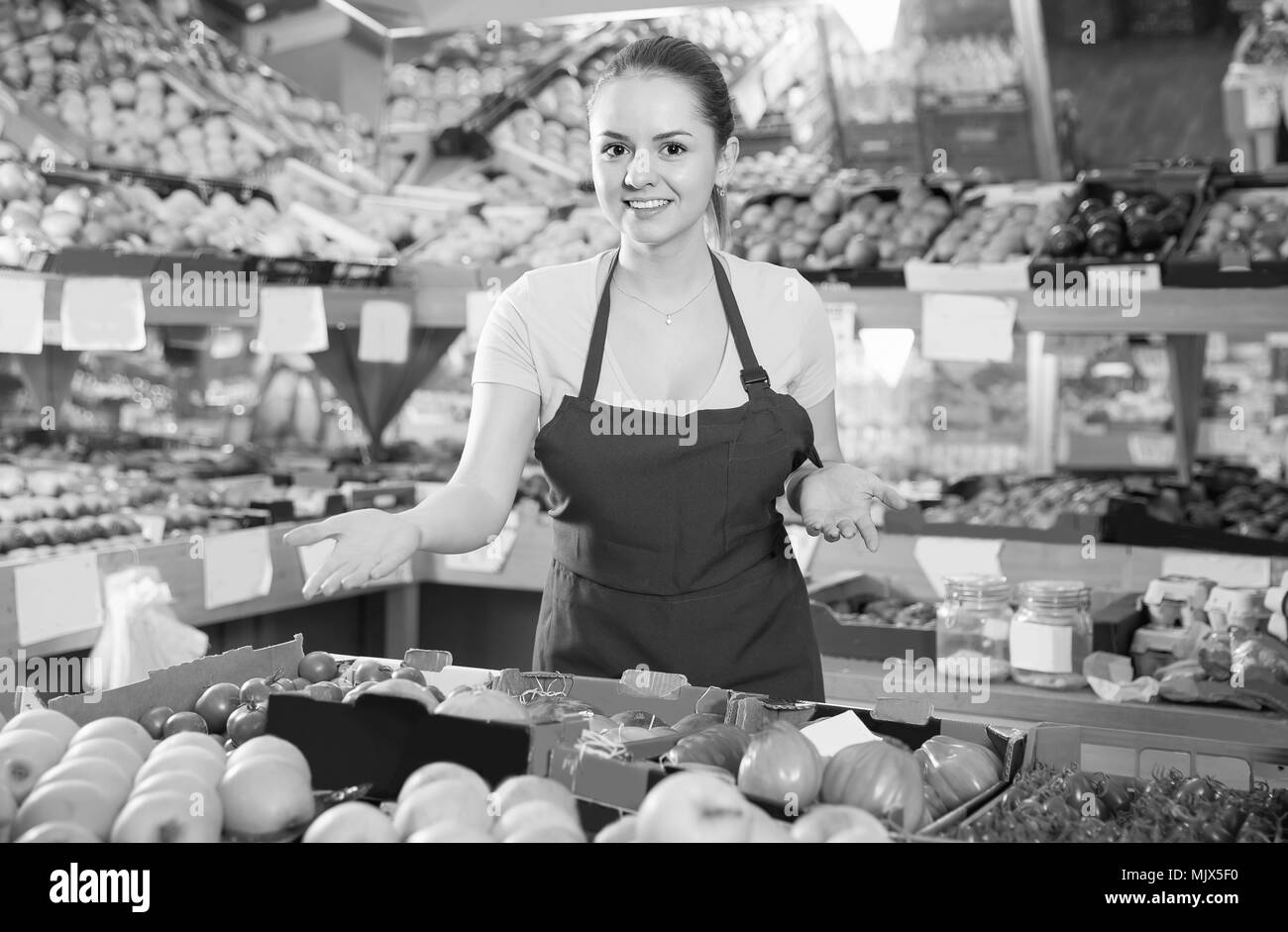 Friendly attractive italian salesgirl proposing fresh fruits and ...