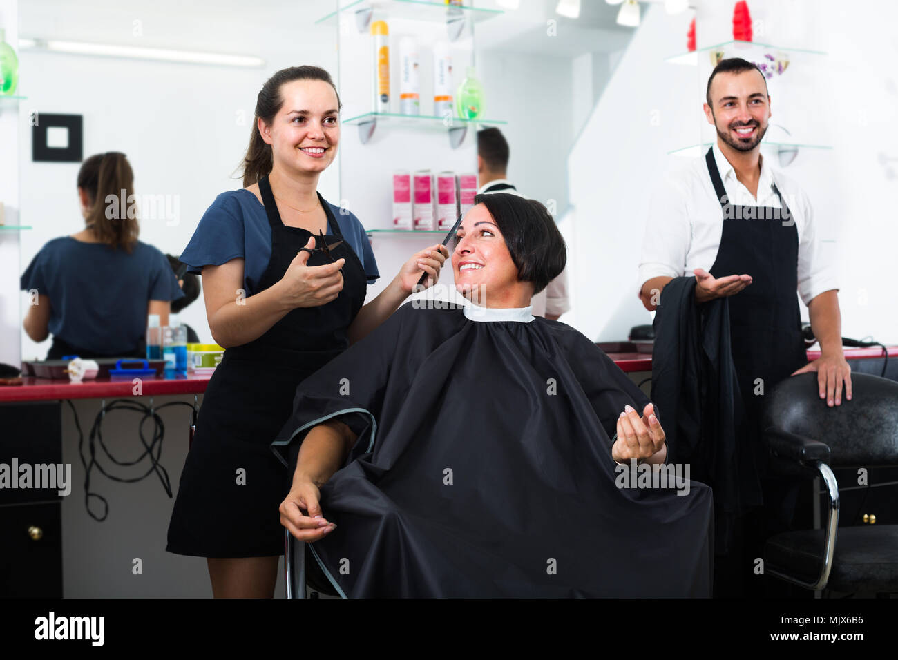woman getting haircut by female hairdresser in salon Stock Photo - Alamy