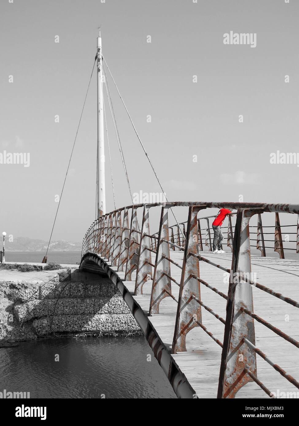 Man gazing at the horizon, on a rusty bridge Stock Photo - Alamy