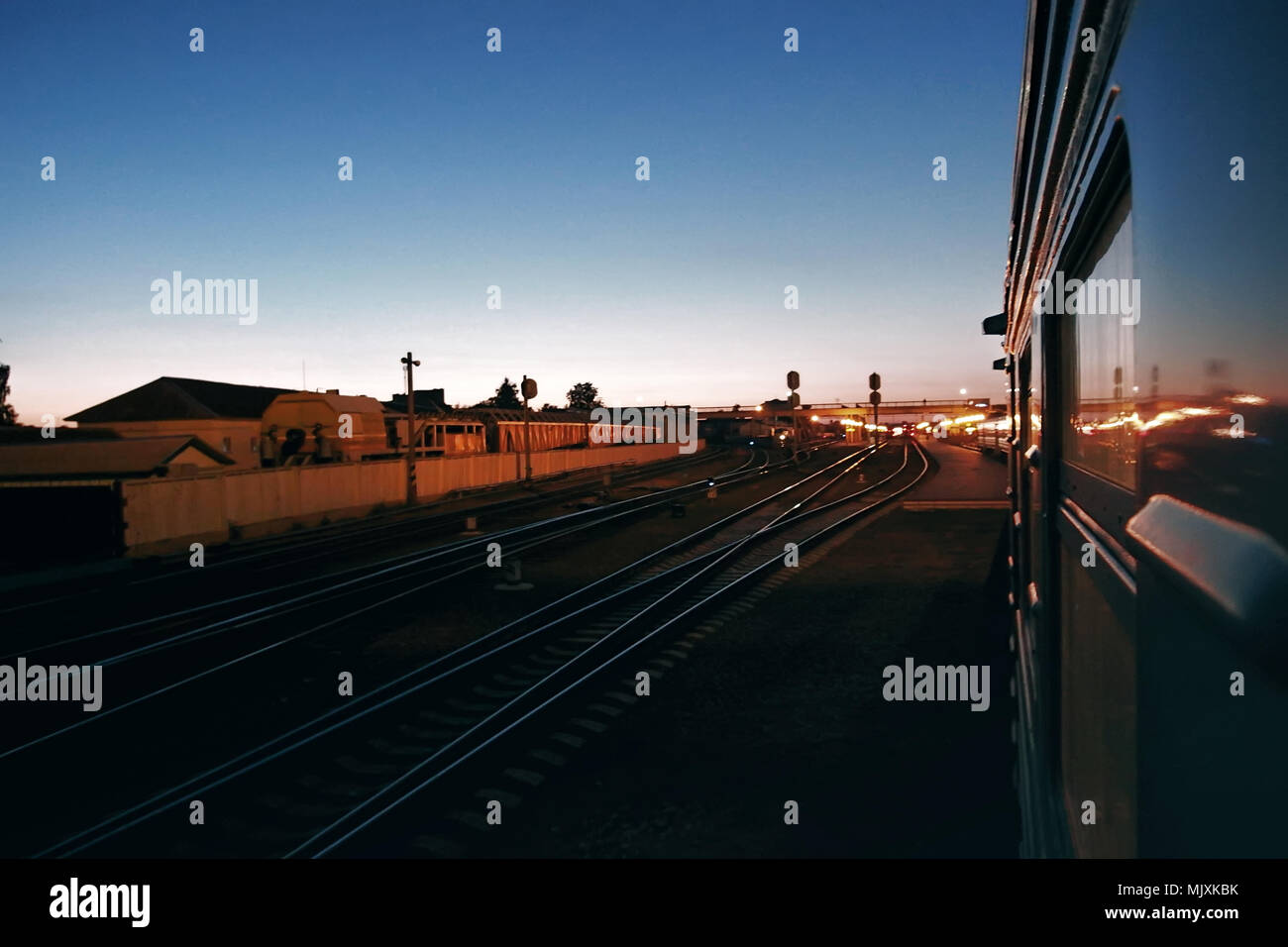 Evening train enters railway station, train arrival, view from window ...