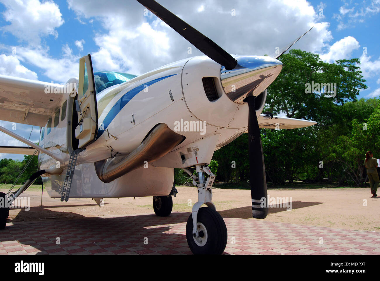 A light aircraft on an airstrip ferrying tourists to and from remote ...