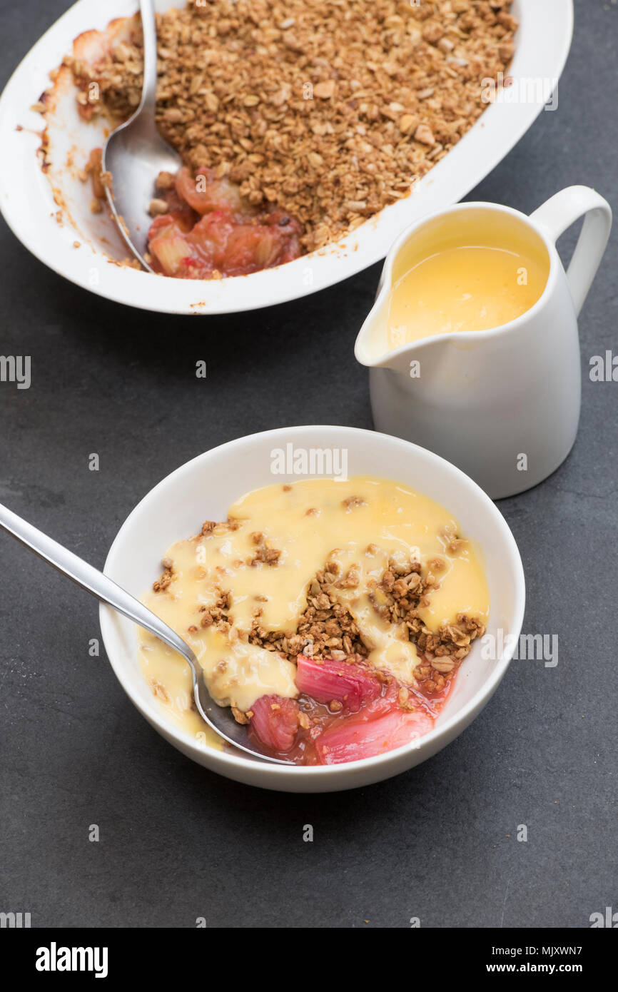 Homemade spiced rhubarb crumble and custard. UK Stock Photo - Alamy