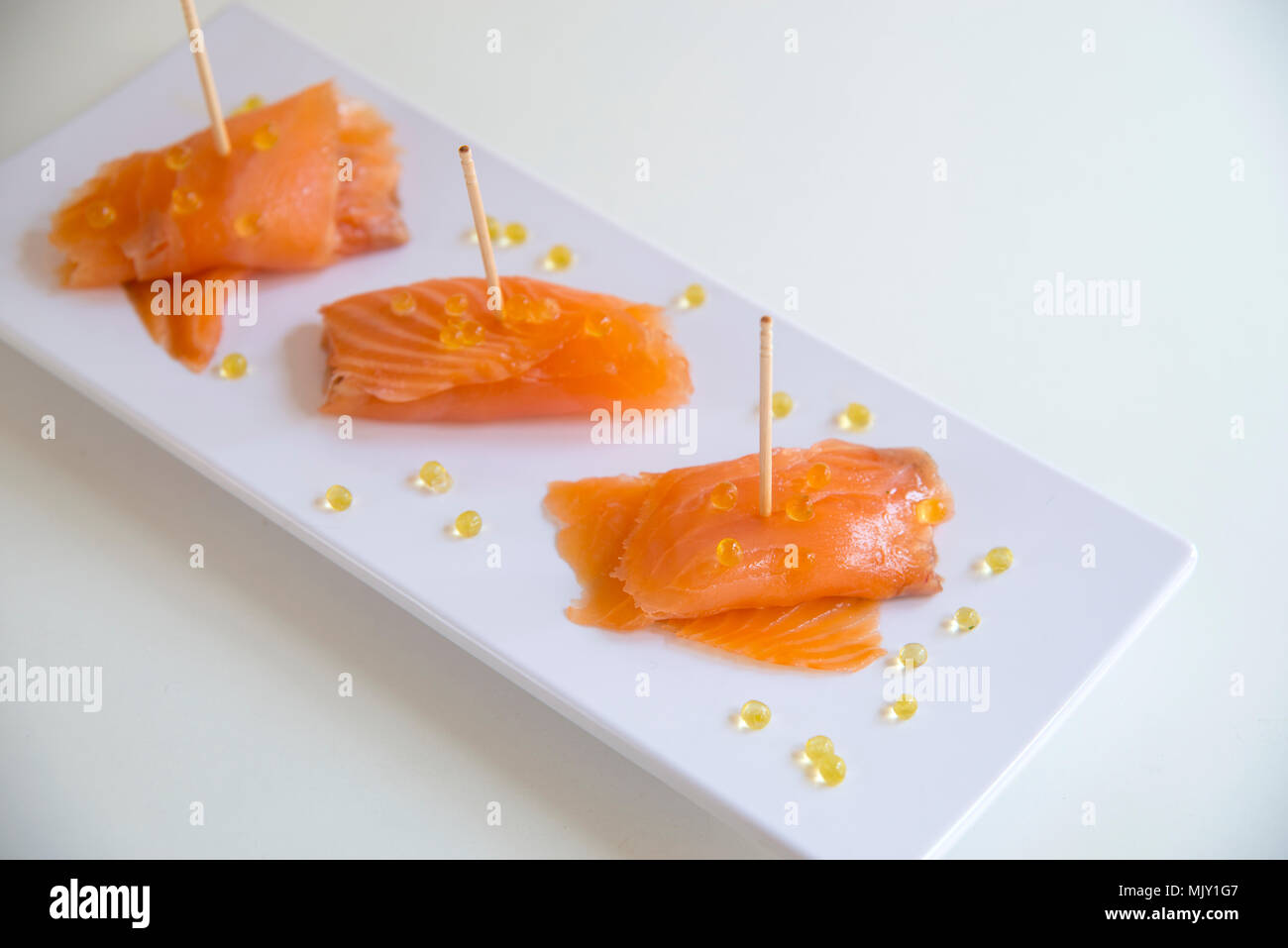 Smoked salmon with pearls of olive oil Stock Photo - Alamy
