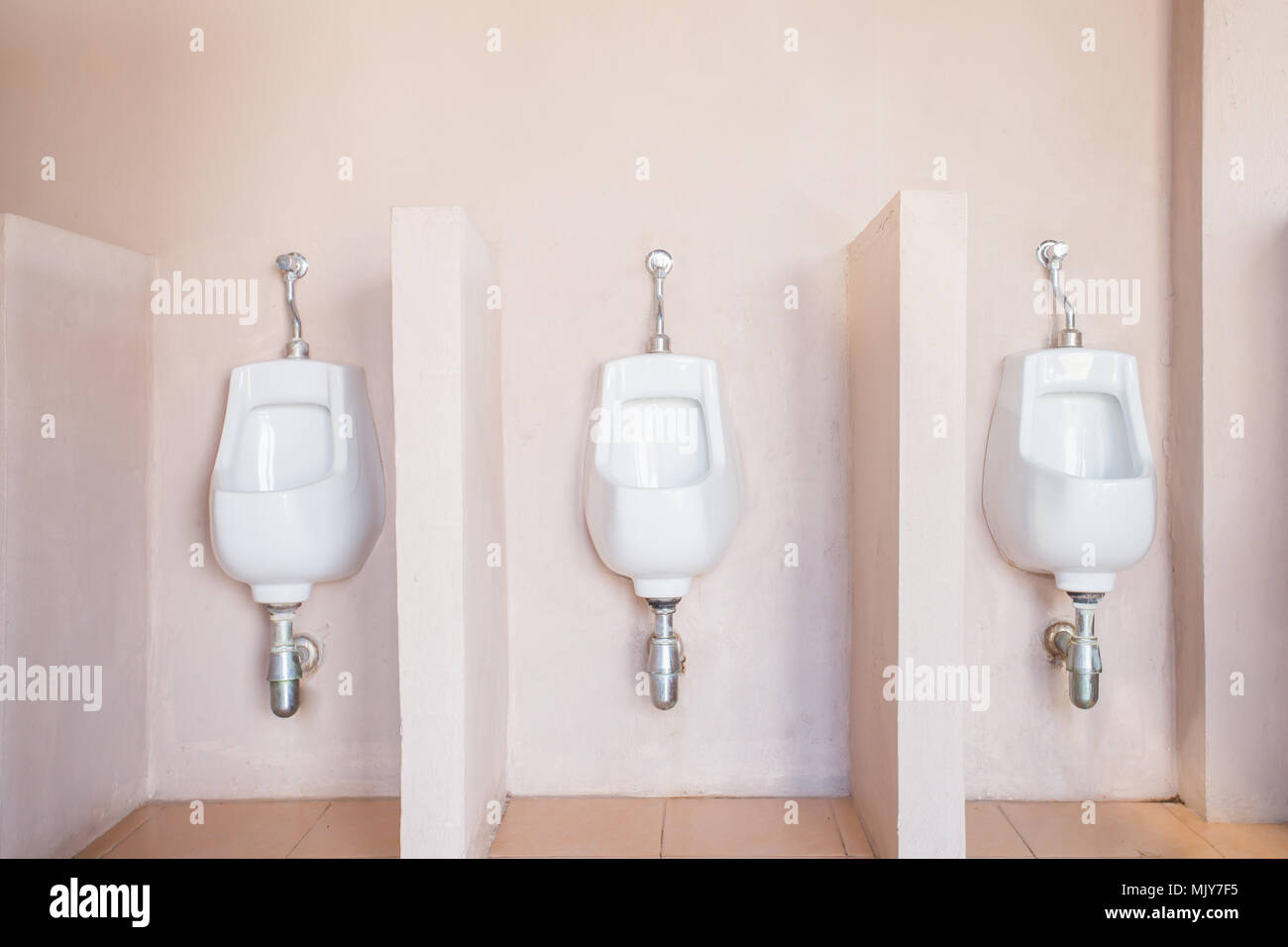 Close up row of outdoor urinals men public toilet Stock Photo - Alamy