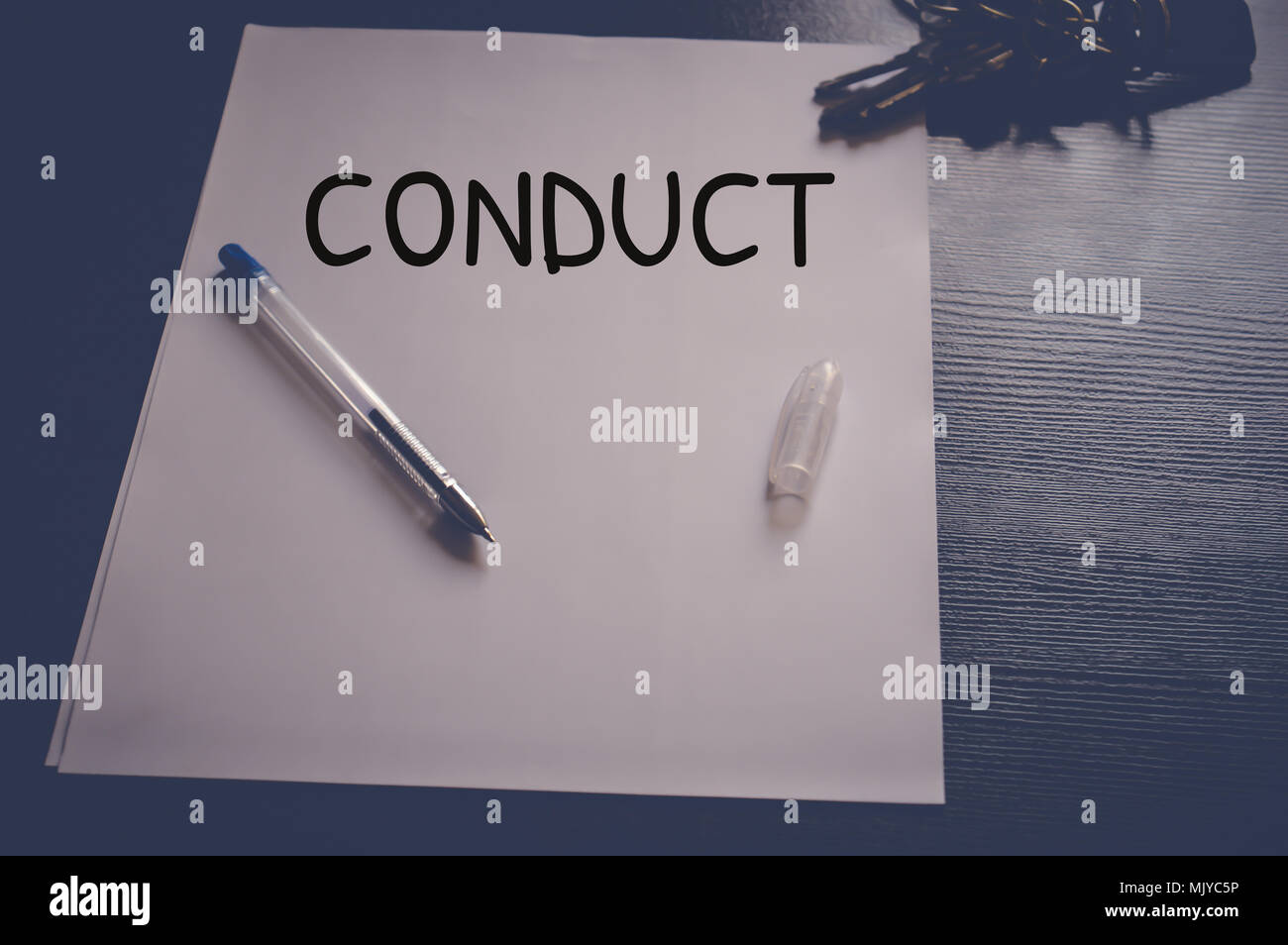 Conduct word uploaded on white paper Stock Photo - Alamy