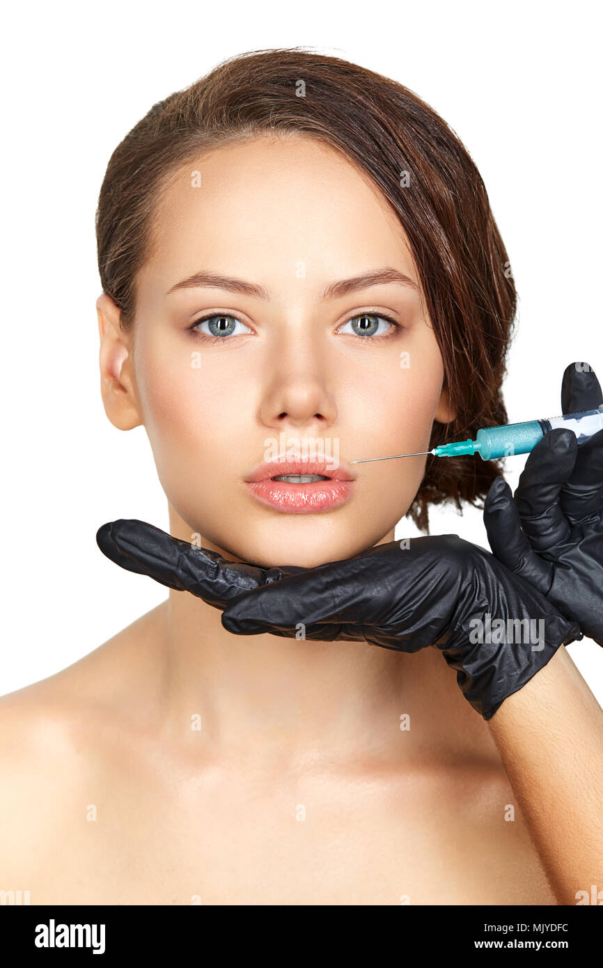 beautiful young woman getting beauty injection. studio shot isolated on ...