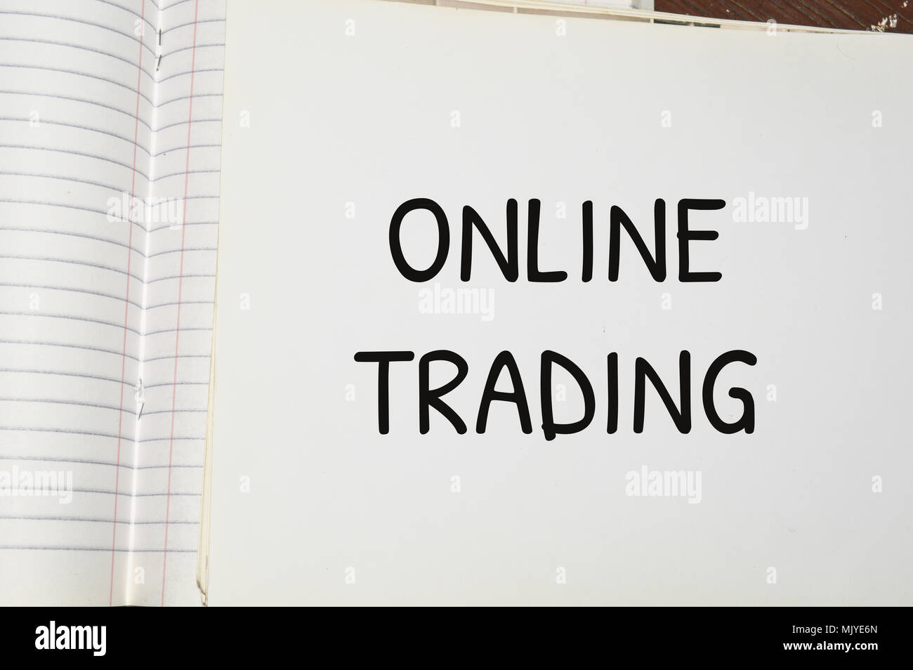 Online trading word written on white paper Stock Photo - Alamy