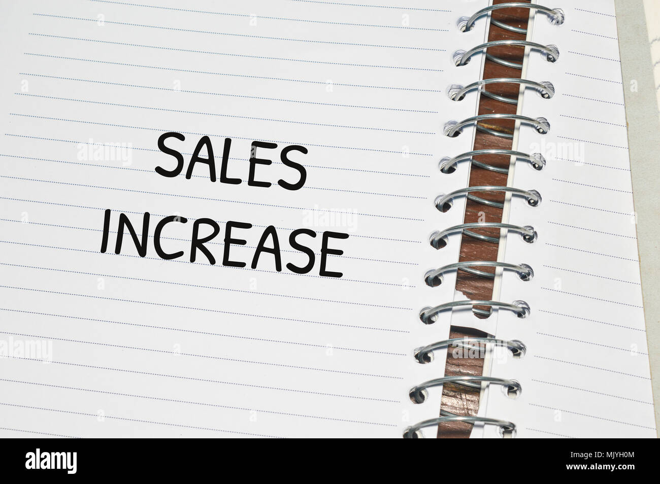 Sales increase word written on white paper Stock Photo - Alamy