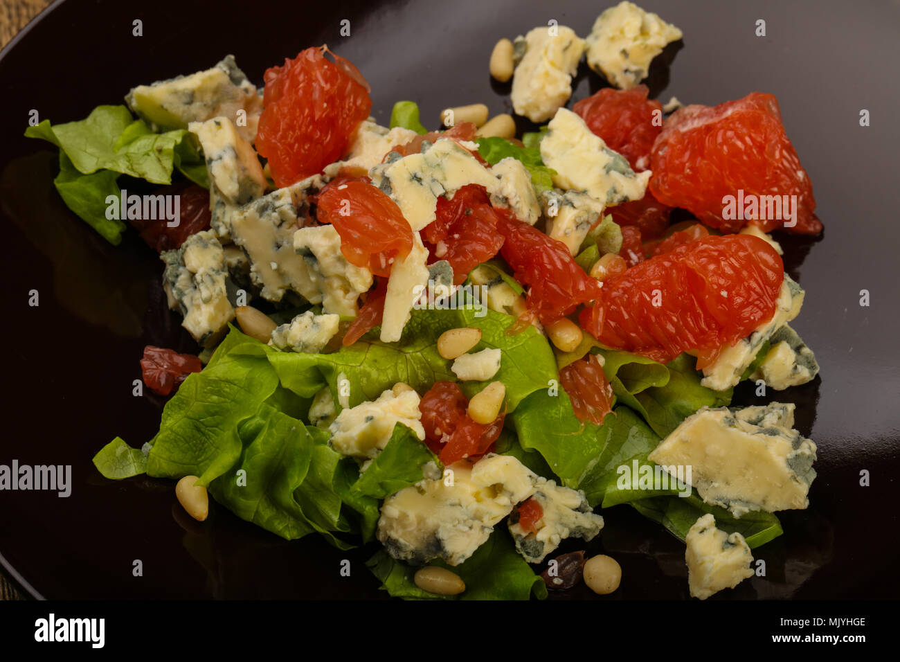 Grapefruit and blue cheese salad with cedar nut Stock Photo - Alamy