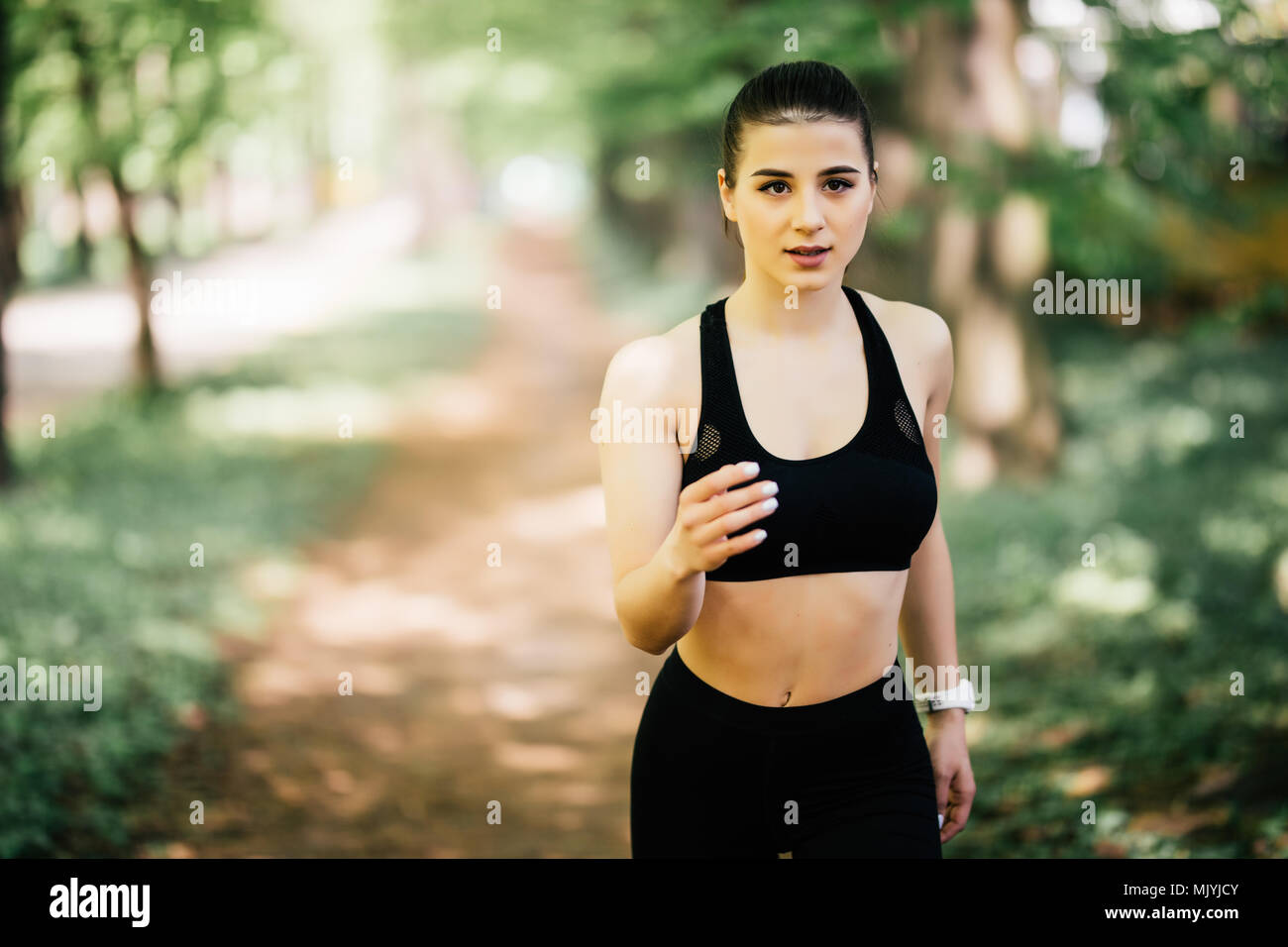Running woman. Female Runner Jogging during Outdoor Workout in a Park ...