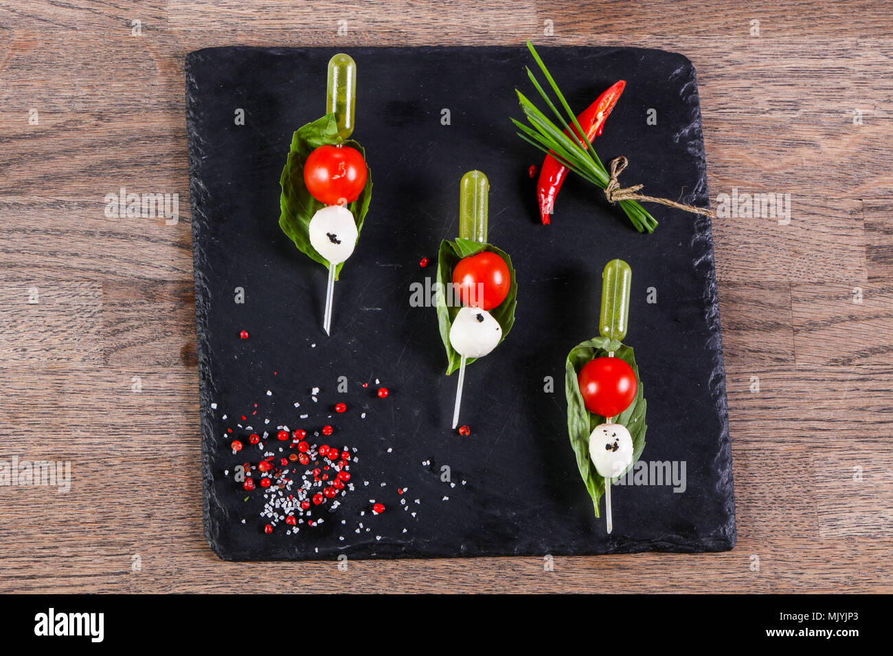 Canape caprese with olive oil Stock Photo - Alamy