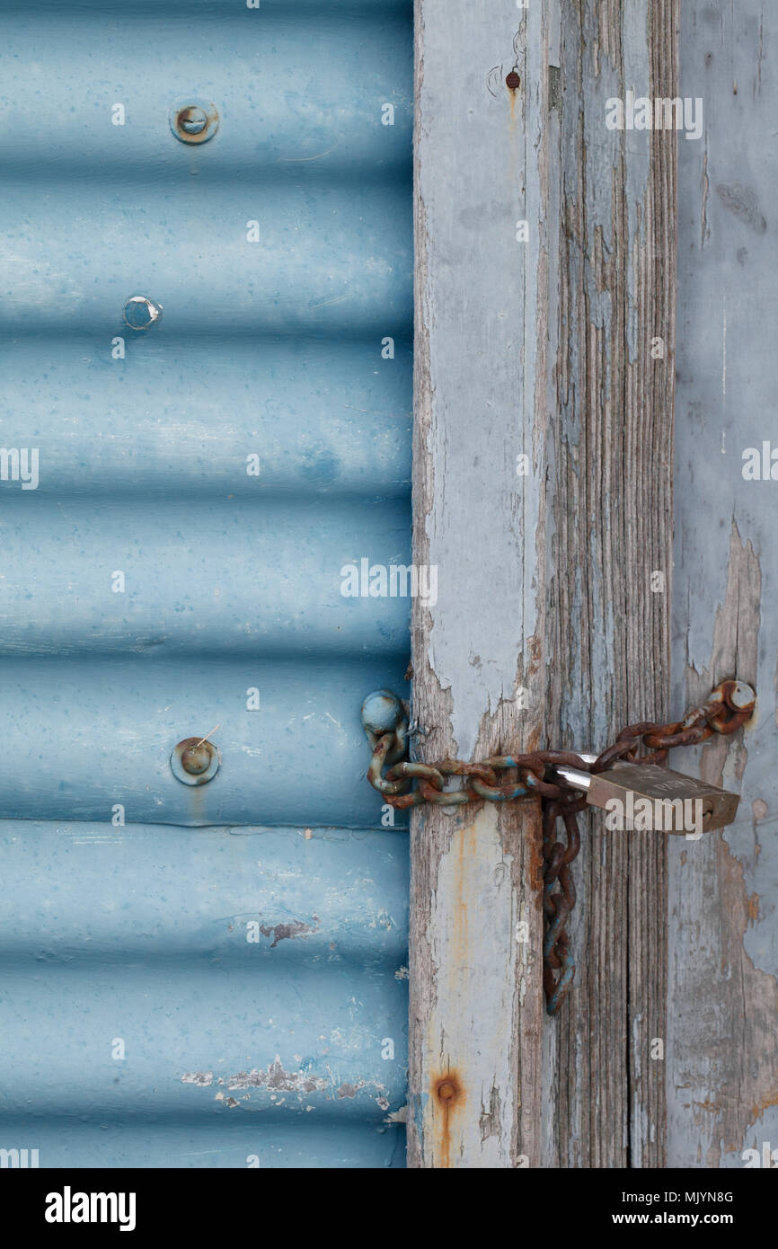 blue corrugated iron building, lock and padlock Stock Photo - Alamy