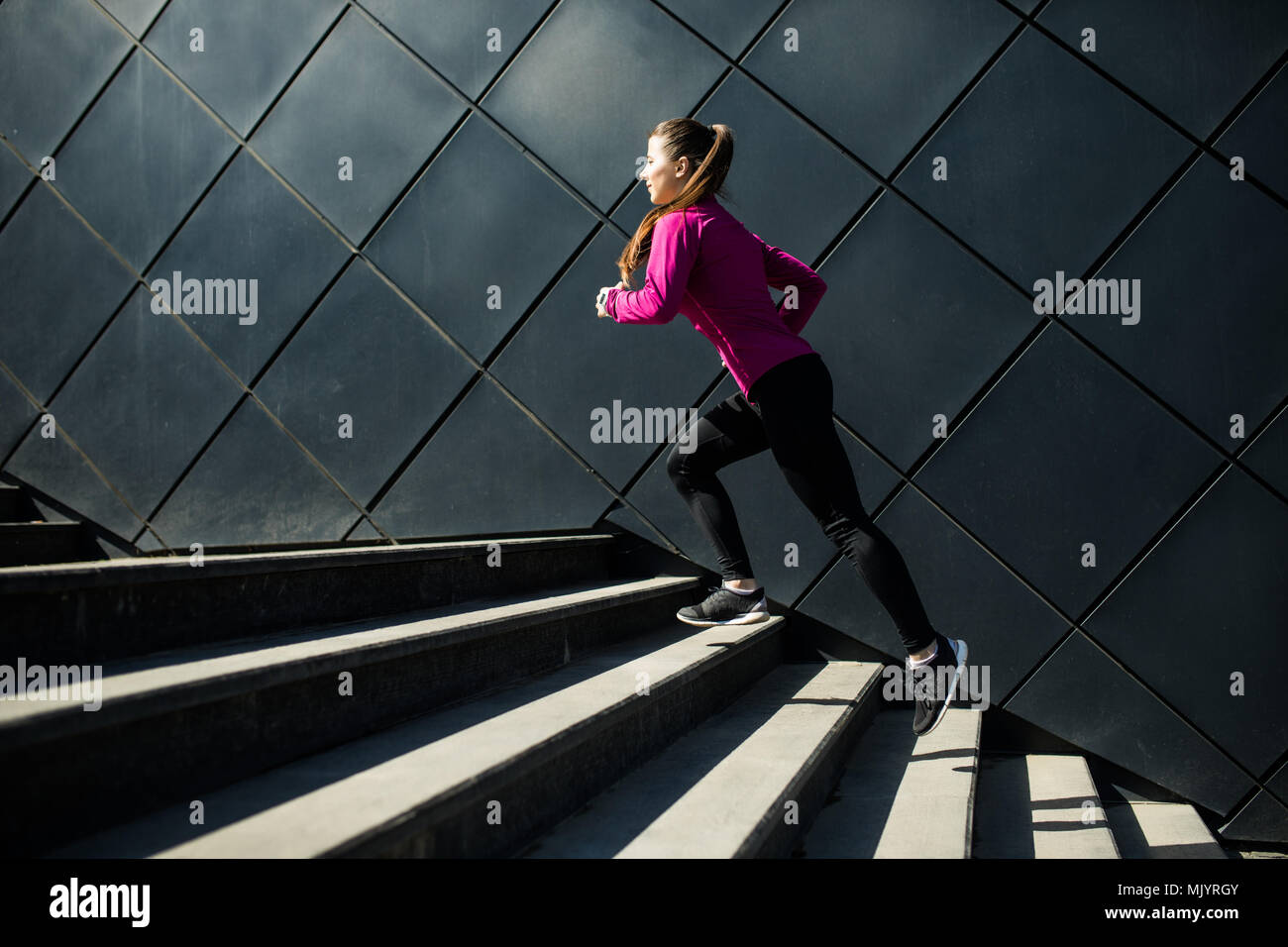 Black man running up stairs hi-res stock photography and images - Alamy