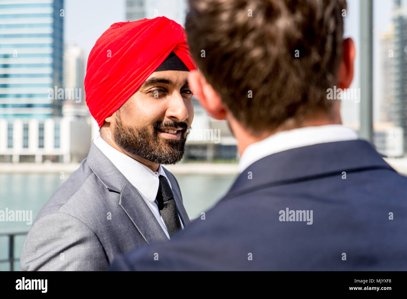 Multiethnic business team meeting outdoors - Three businessmen talking ...