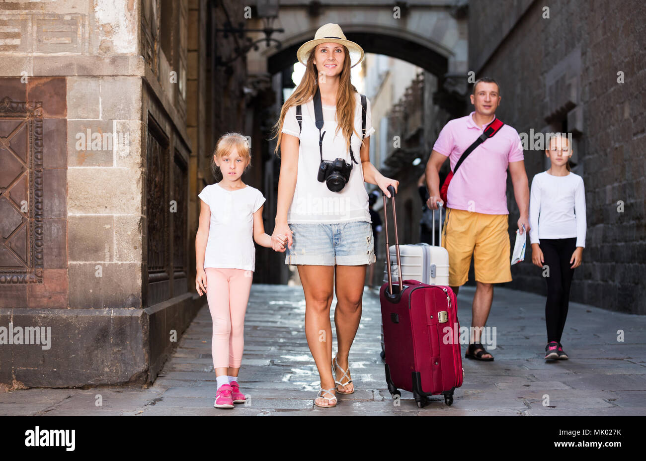 Family of four travelling together on city, walking with baggage Stock ...