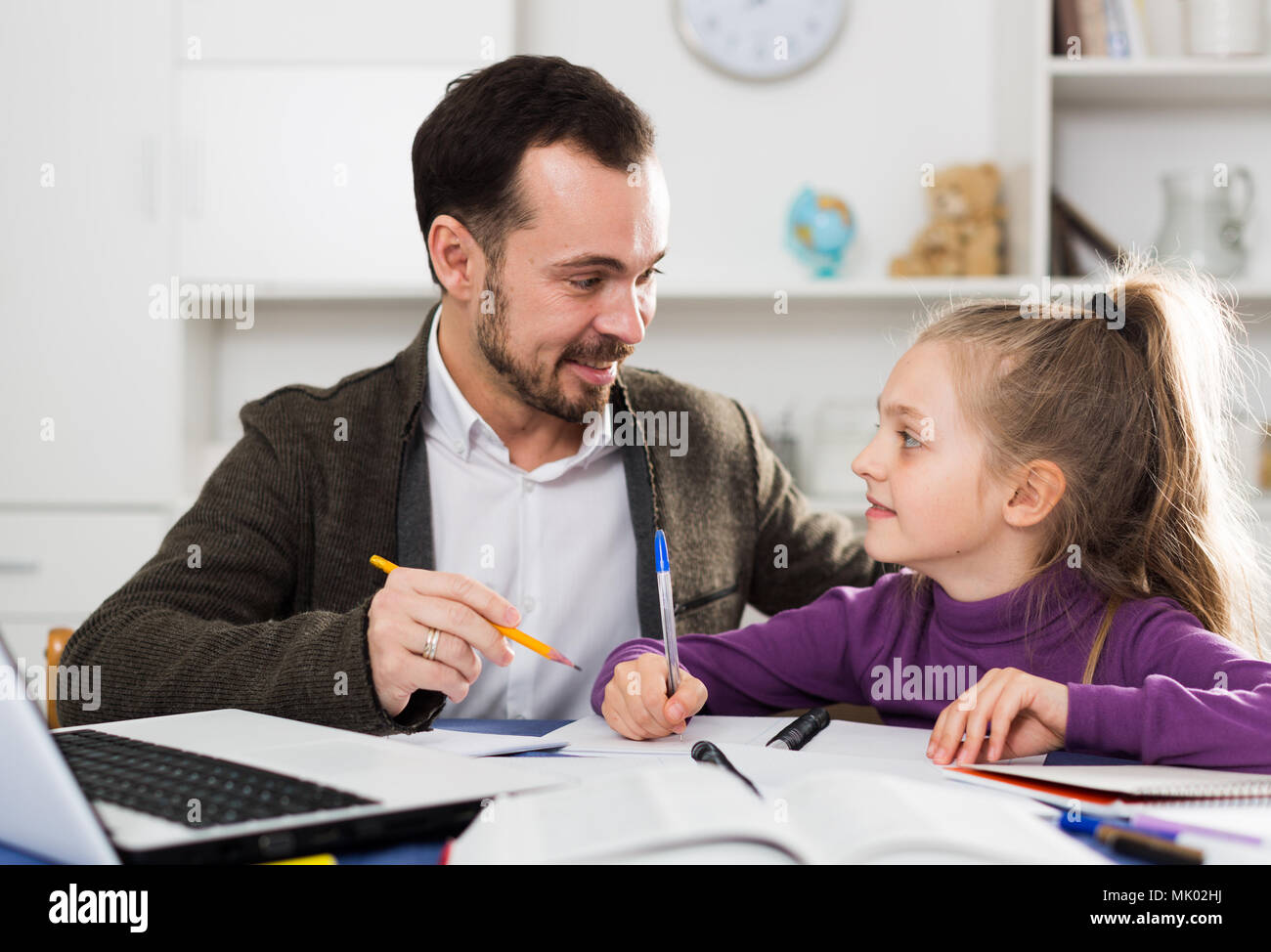 Young father helping his daughter to prepare homework at home Stock ...