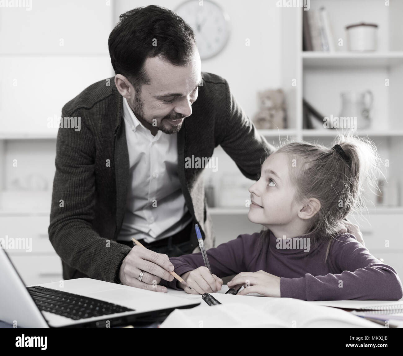 Father helping his child to do homework at home Stock Photo - Alamy