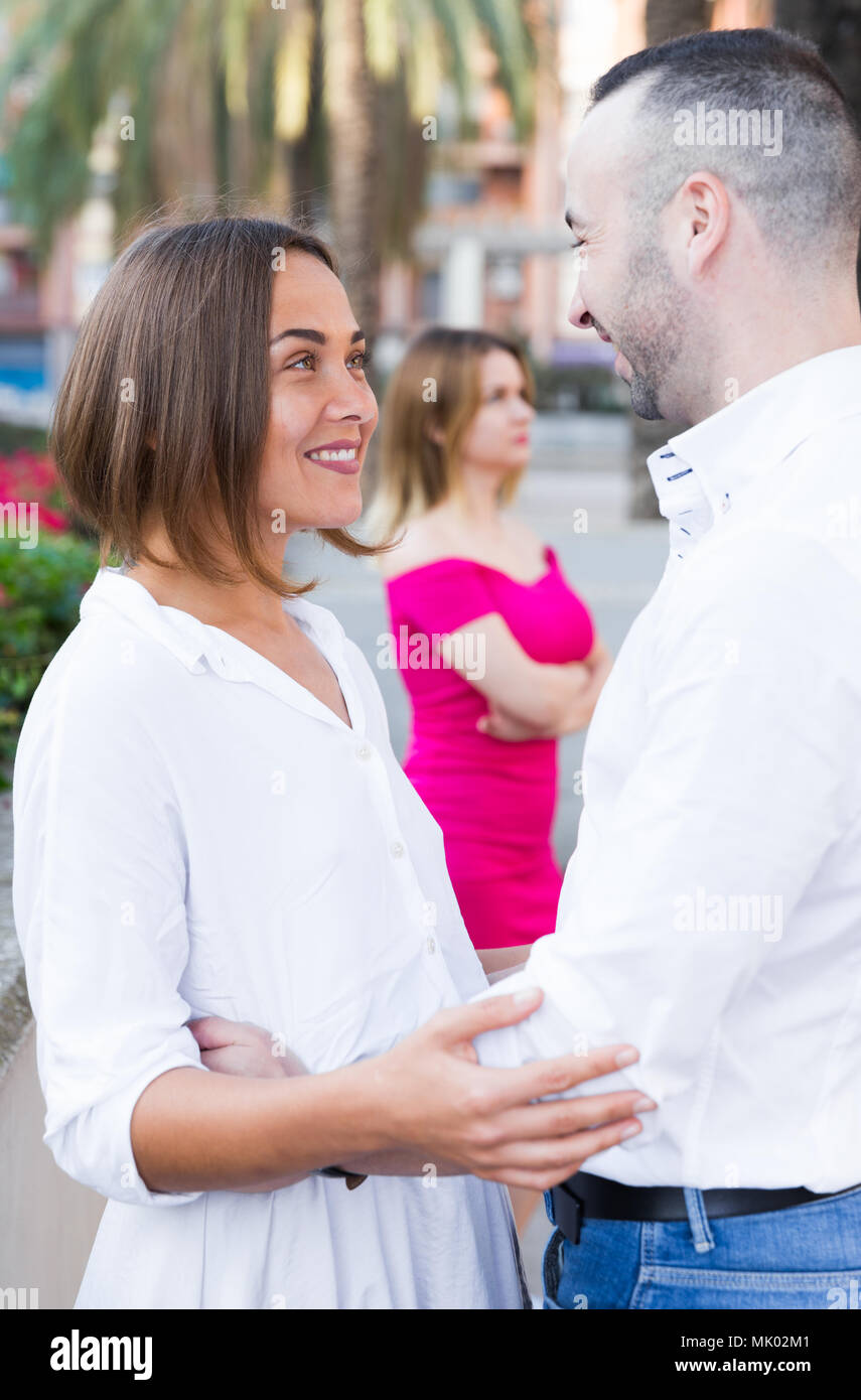 Lonely female is envying to smiling couple on the street Stock Photo ...