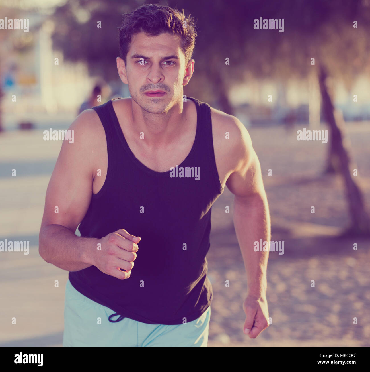 Sporty man during morning running training outdoors Stock Photo - Alamy