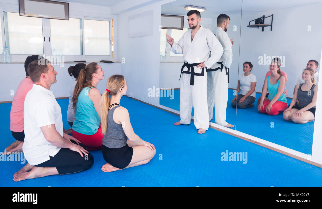 Karate instructor is showing new martial moves to adults in karate ...