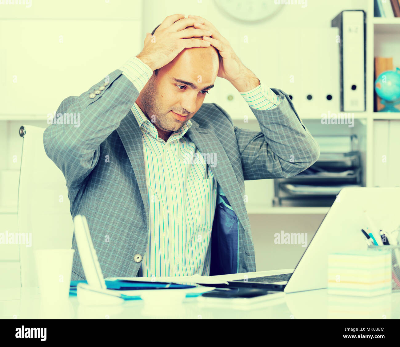 Busy man in suit worrying at the computer with cup of water Stock Photo ...