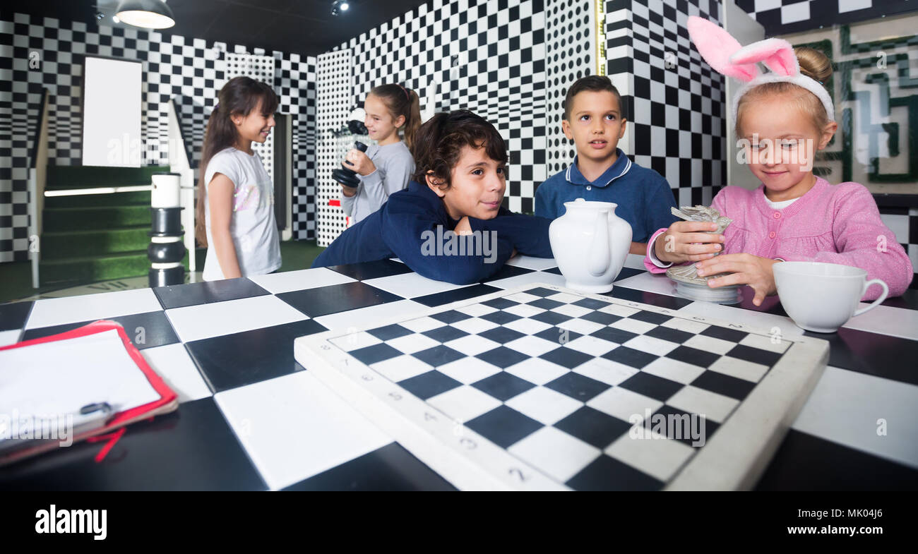 Captured children play in quest room in chess style Stock Photo - Alamy