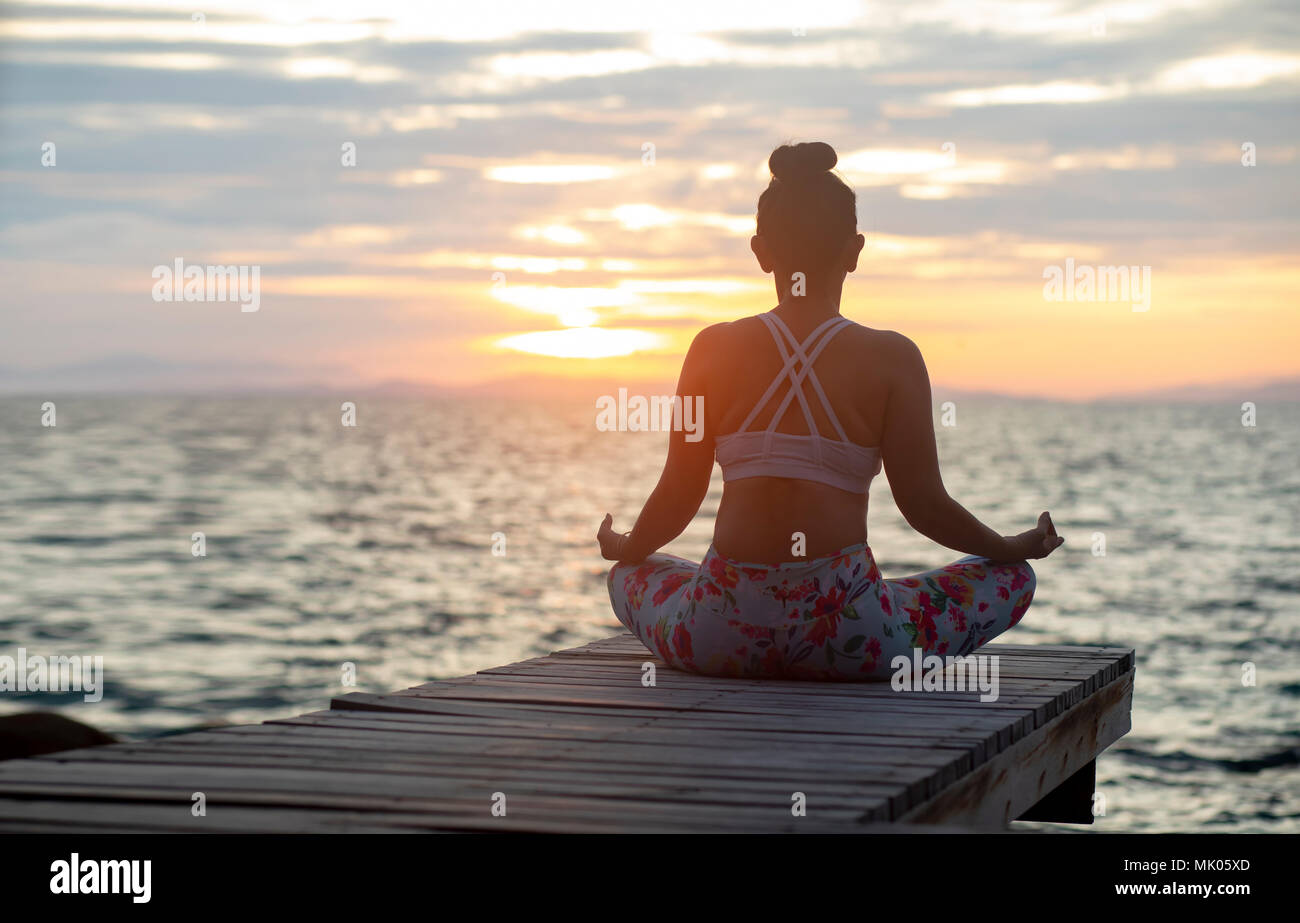Beautiful woman meditating sitting in hi-res stock photography and ...
