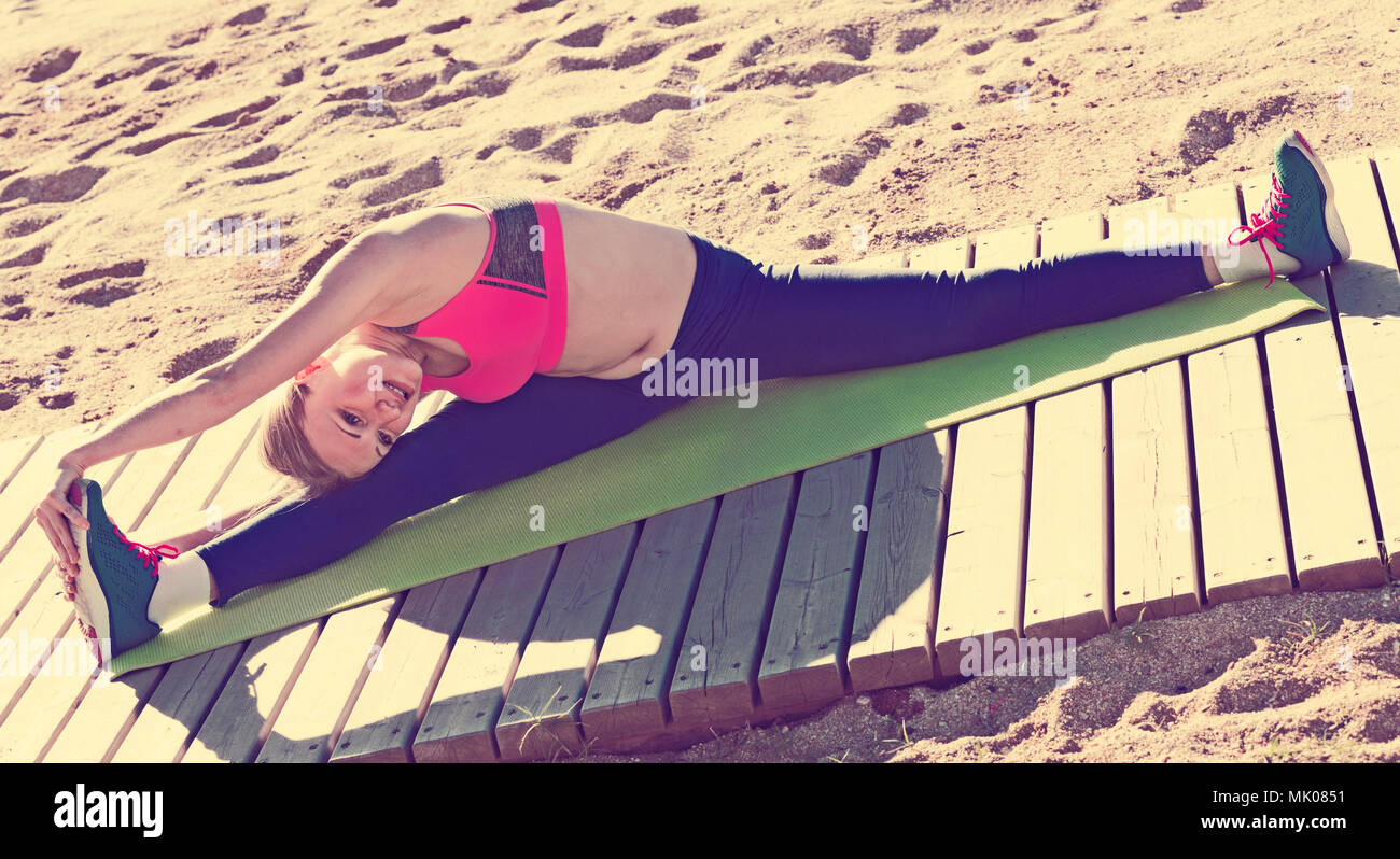 Female is stretching on the beach Stock Photo - Alamy