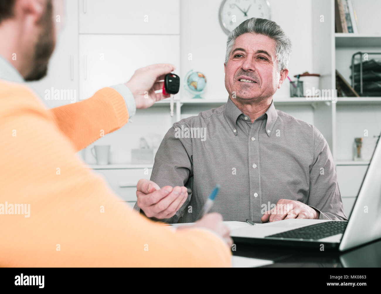 Mature man and manager signed car purchase contract at office and hand ...