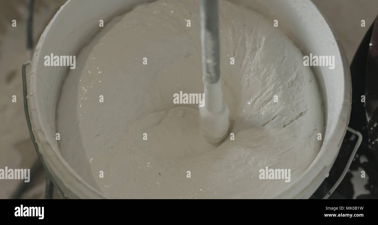 stirring putty in the bucket Stock Photo - Alamy