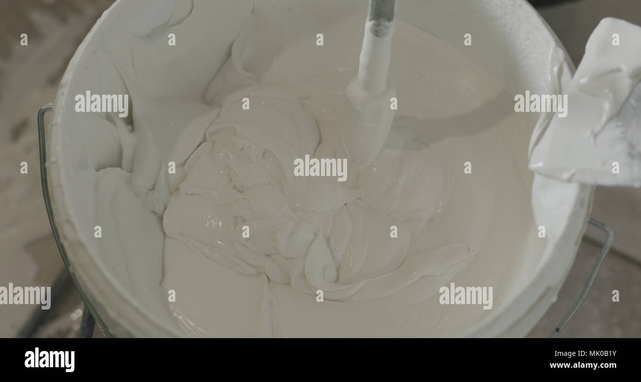 stirring putty in the bucket Stock Photo - Alamy