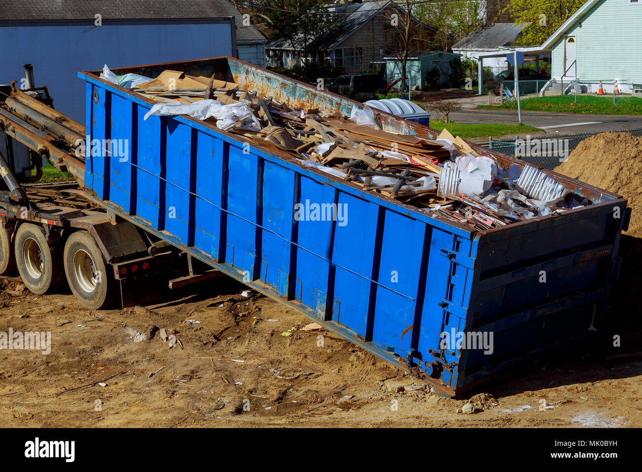 Truck loading a recycling garbage full skip waste management container ...