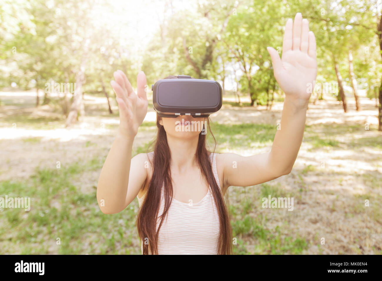 Woman using virtual reality headset outdoor, nature and technology ...