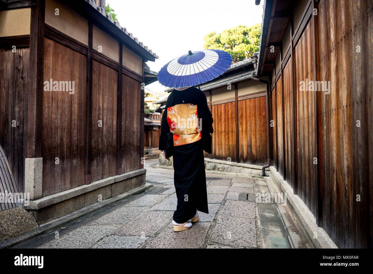 Japanese woman wearing traditional dress and walking outdoors Stock ...