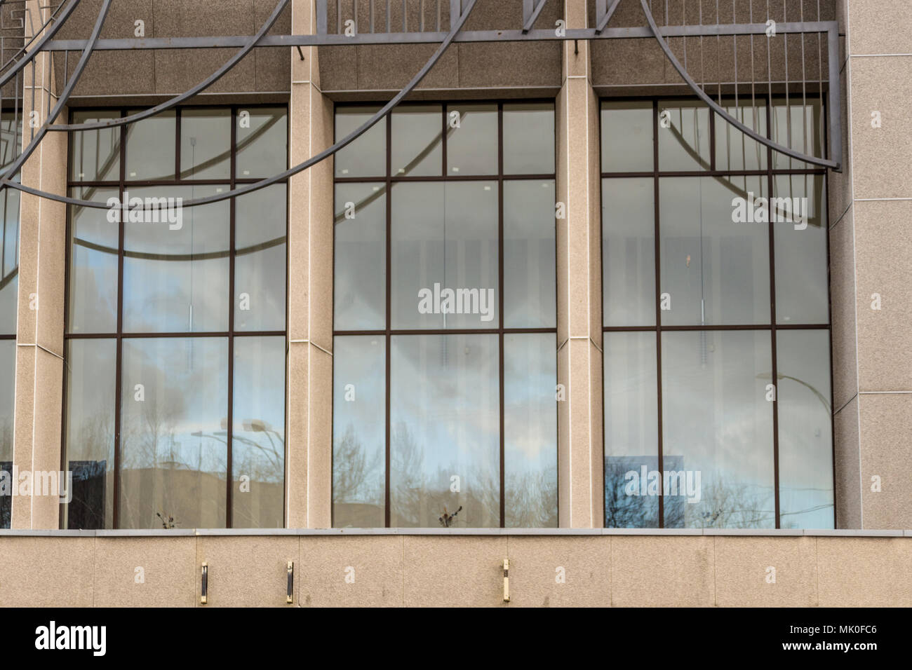 Large windows with wrought iron grating, building facade Stock Photo ...