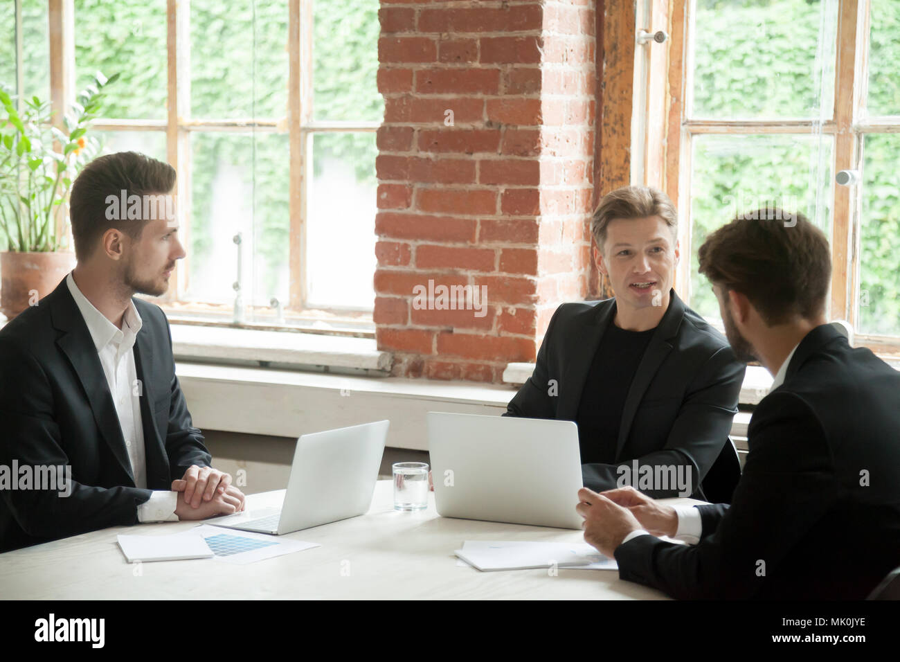 Businessmen discussing company investment with potential partner Stock ...