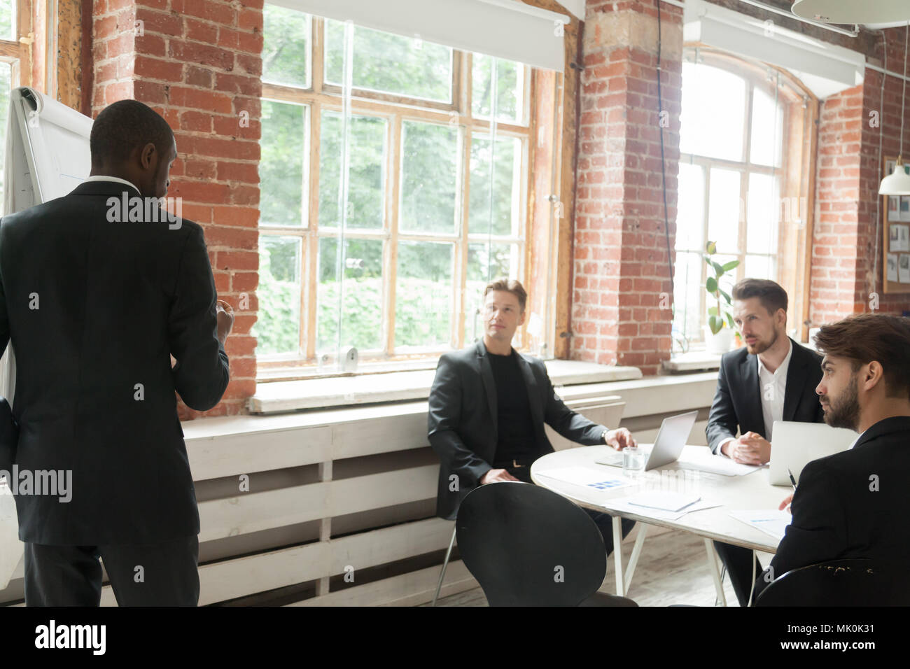Company briefing in diverse work group Stock Photo - Alamy
