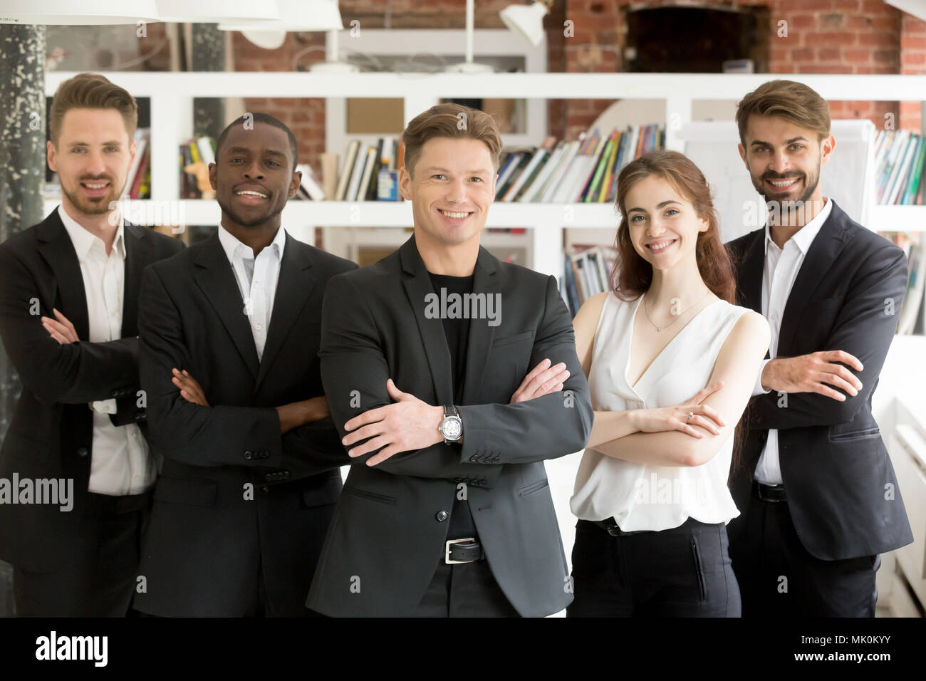 Smiling diverse team posing with arms crossed Stock Photo - Alamy