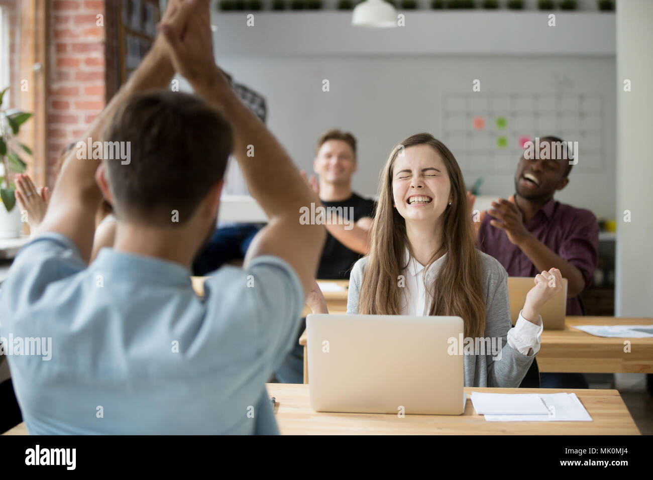 Happy female celebrating success working hi-res stock photography and ...