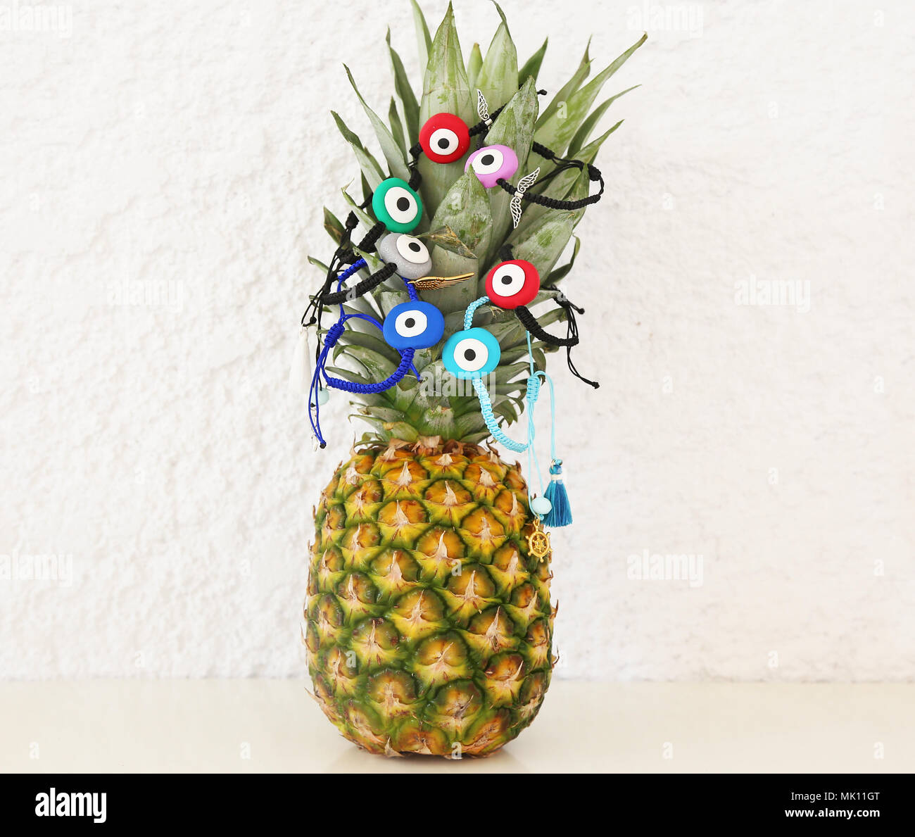 evil eye bracelets advertisement on pineapple - exotic fruit with greek ...