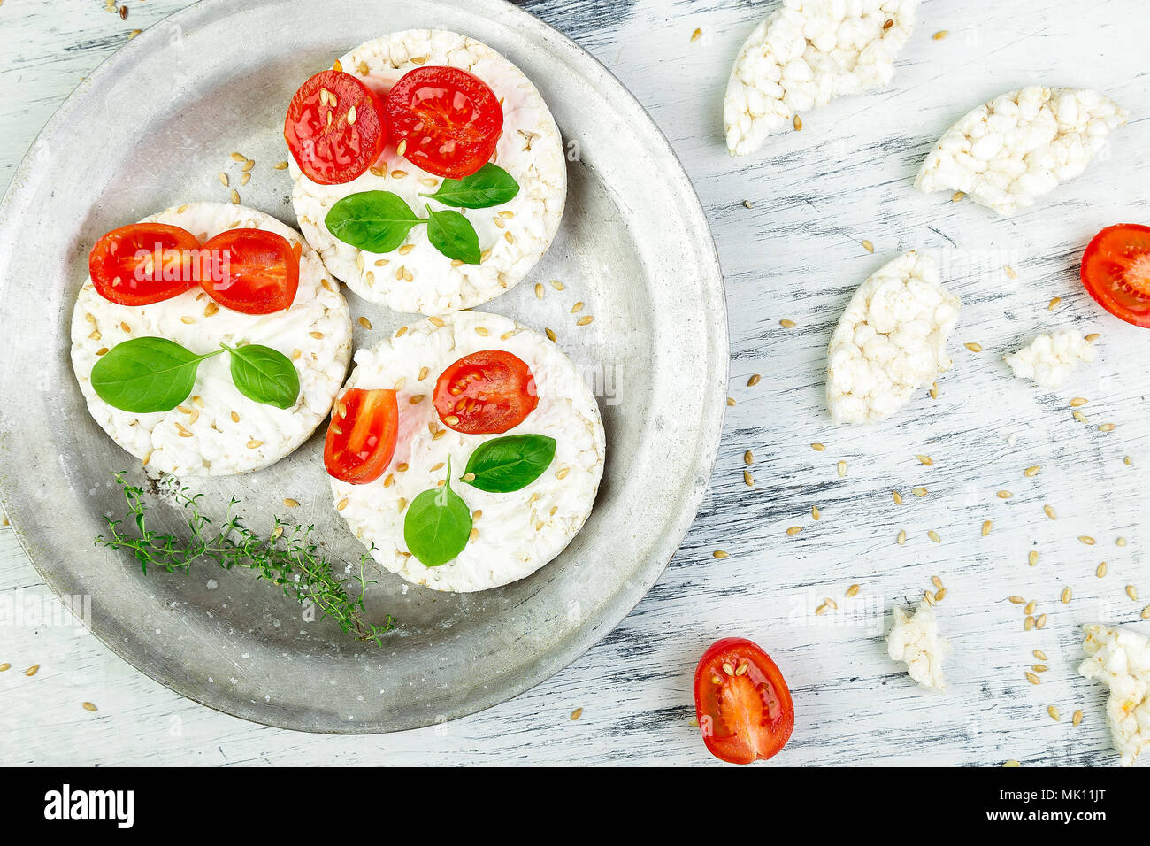 Healthy Rice Cakes with cherry tomatoes, cheese feta, basil and sesame ...