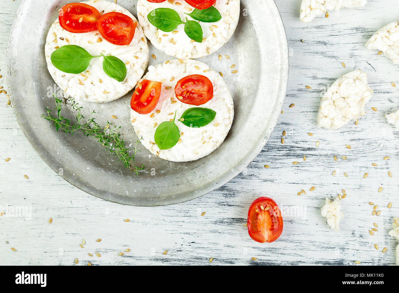 Healthy Rice Cakes with cherry tomatoes, cheese feta, basil and sesame ...