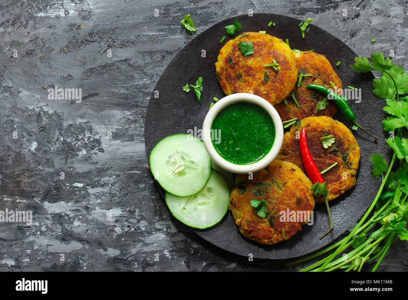 Aloo Tikki / Indian snack Potato Patties served with cilantro chutney ...