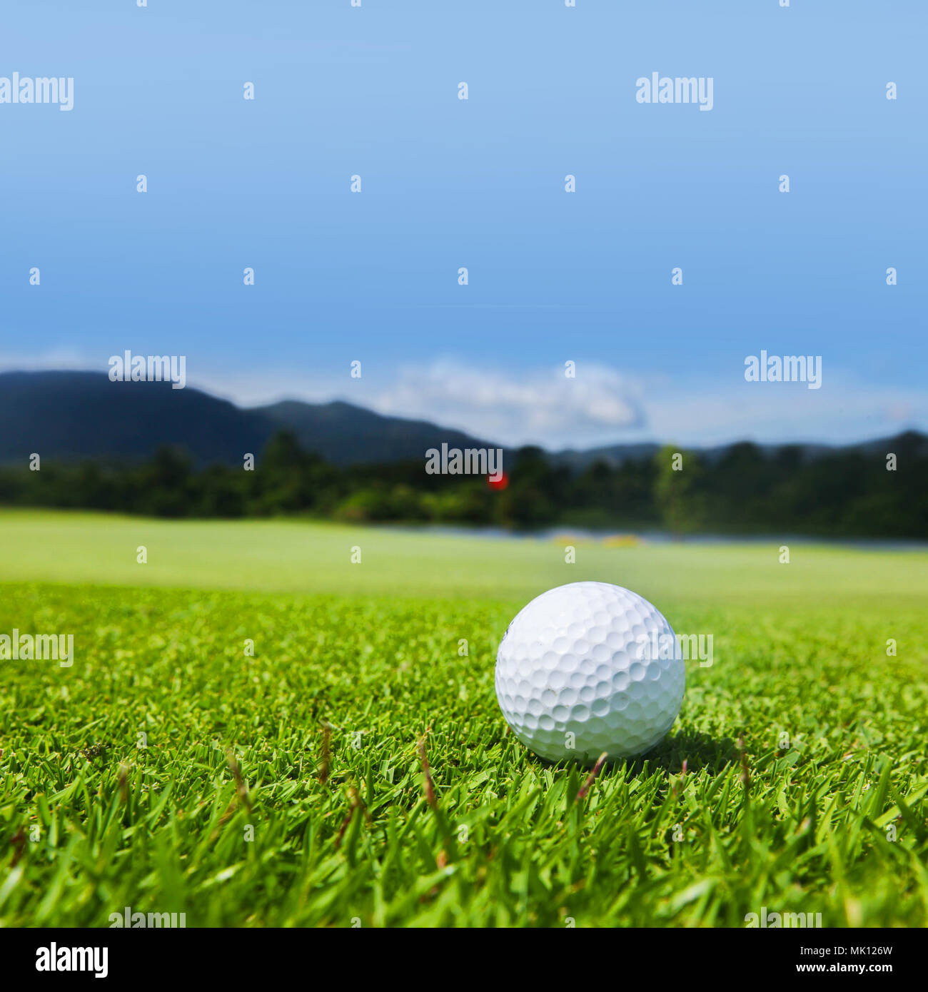 Golf ball on course, beautiful landscape with mountains on background ...