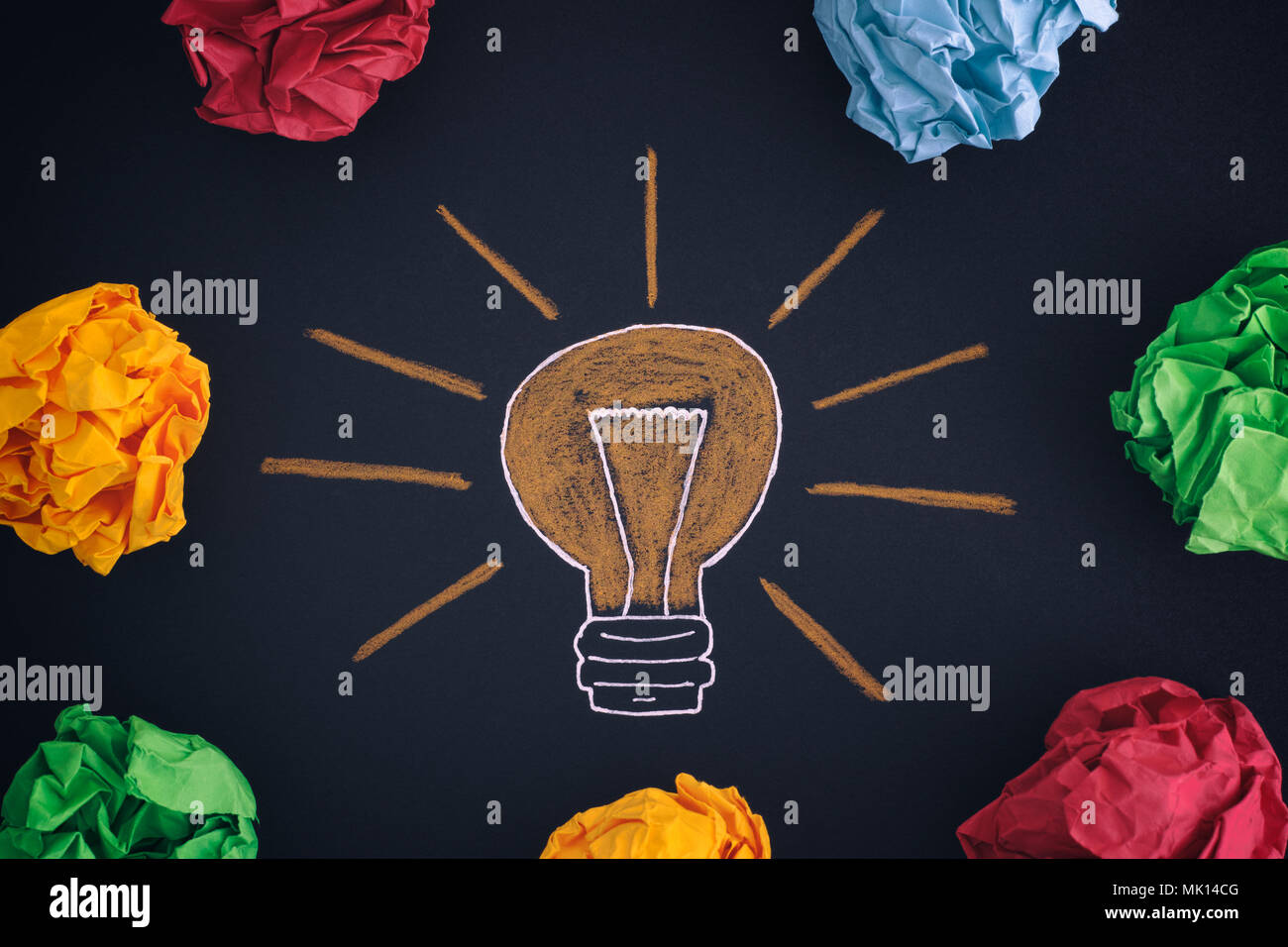 New Idea Concept. Drawing of a light bulb and colourful crumpled paper ...