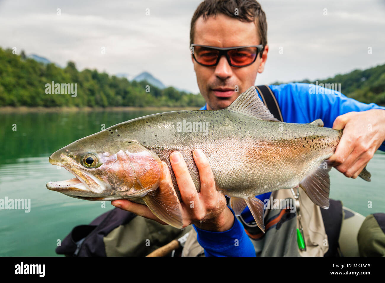 Man holding rainbow trout hi-res stock photography and images - Alamy