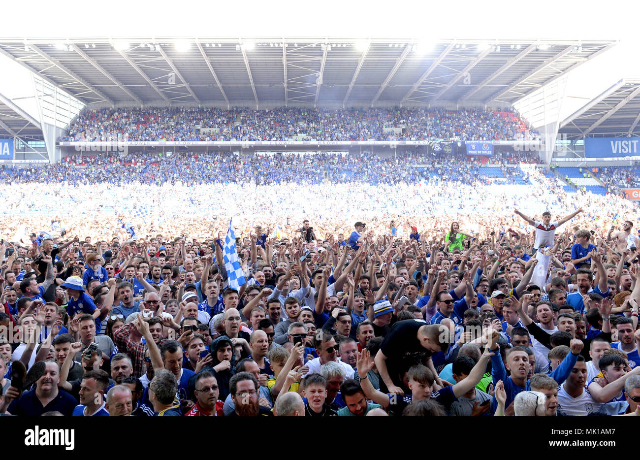 Cardiff City fans flood the pitch to celebrate their promotion to the ...