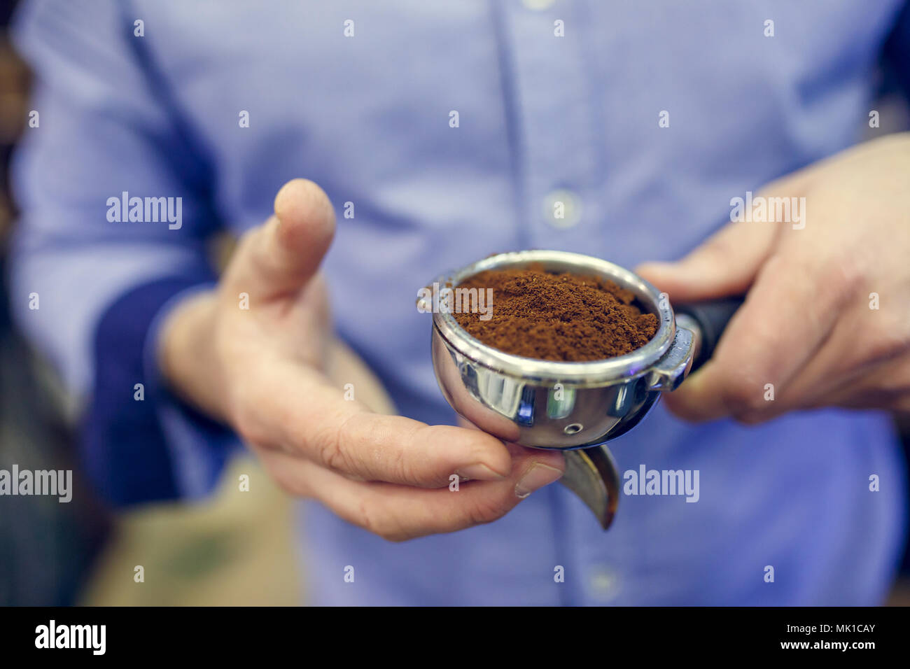 Photo of barista man with ground coffee in hands Stock Photo - Alamy