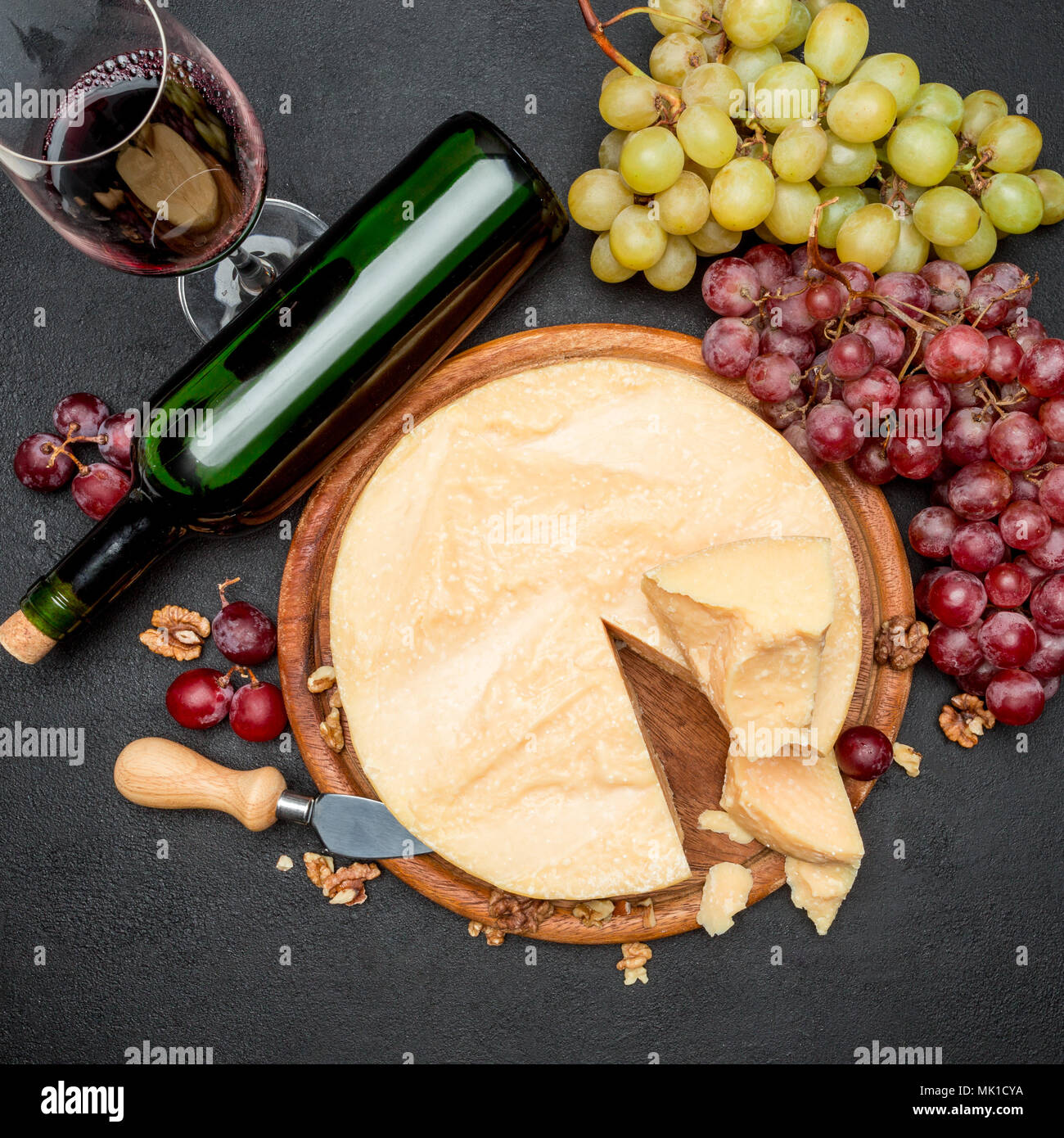 Whole round Head parmesan cheese, wine and grapes Stock Photo - Alamy